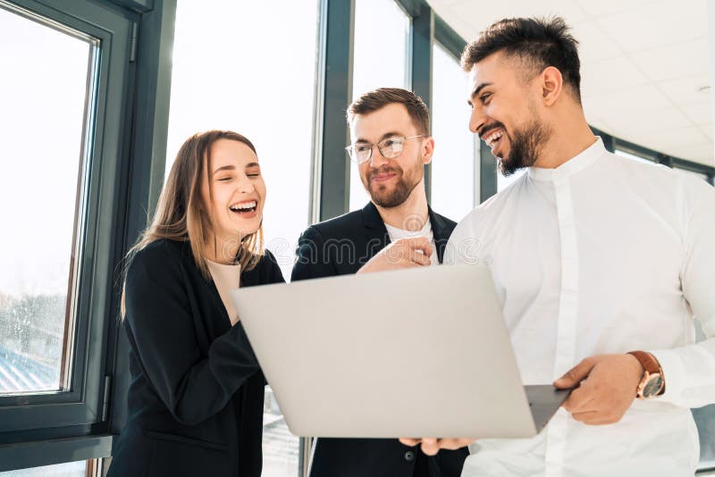 Cheerful Office Workers with Laptop. Stock Photo - Image of business ...