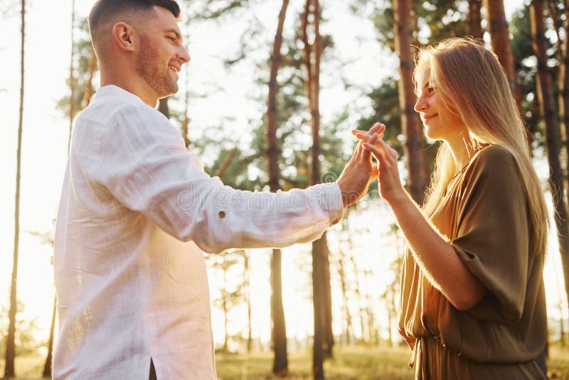 Cheerful People. Happy Couple is Outdoors in the Forest at Daytime ...