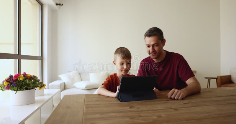Cheerful Positive Dad Helping Little Son To Use Tablet Stock Video ...