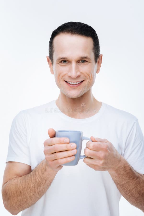 Cheerful Positive Man Holding a Cup of Tea Stock Photo - Image of ... Cheerful Positive Man Holding a Cup of Tea Stock Photo - Image of ...