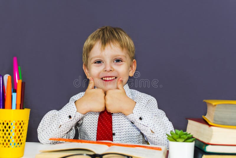 Cheerful Preschool Boy at the Table with Books Stock Image - Image of ...