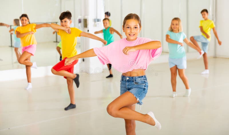 Cheerful Preteen Girl Learning Energetic Dance in Choreography Class ... Cheerful Preteen Girl Learning Energetic Dance in Choreography Class ...