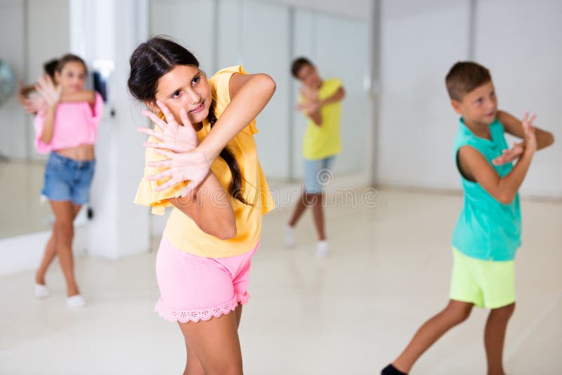 Cheerful Preteen Hispanic Girl Learning Energetic Dance in Choreography ... Cheerful Preteen Hispanic Girl Learning Energetic Dance in Choreography ...