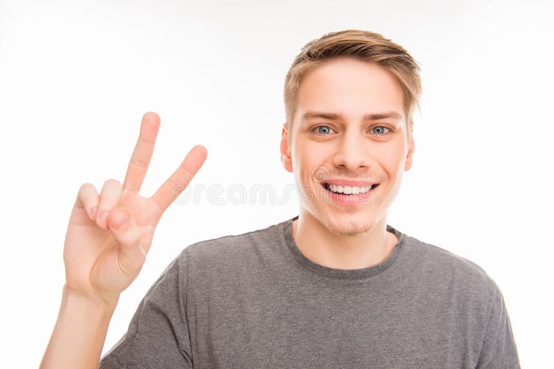 Cheerful Pretty Man in Gray T-shirt Gesturing with Two Fingers Stock ...