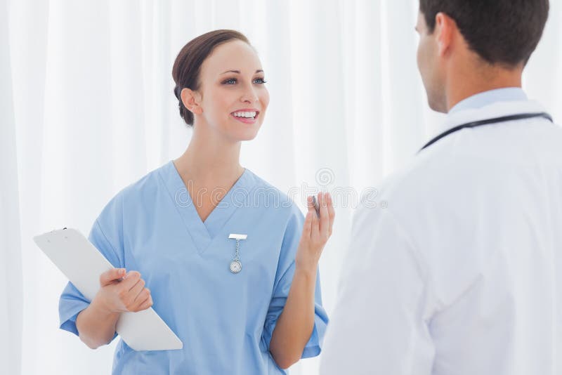 Cheerful Pretty Surgeon and Doctor Talking Together Stock Photo - Image ...