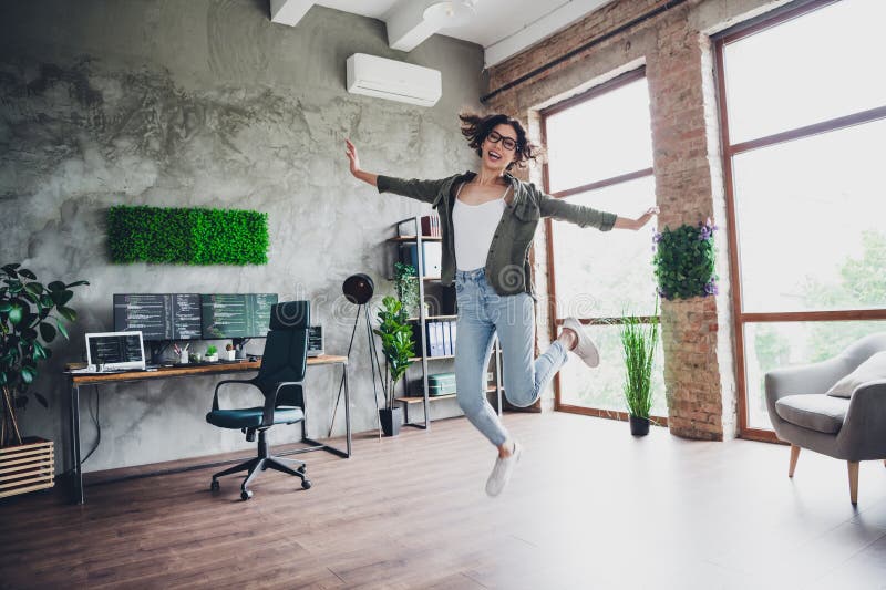 Cheerful Programmer Jumping in a Modern Home Office Surrounded by ...