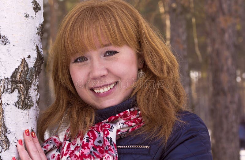 Of a Cheerful Red-haired Girl in the Park among Birches. Stock Image ...