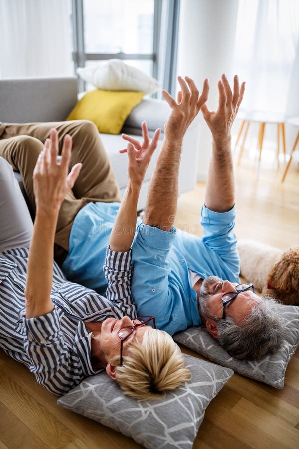 Cheerful Senior Couple Enjoying Life Together Having Fun At Home Stock