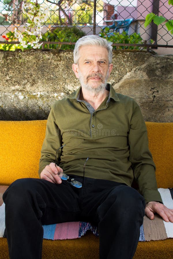 Cheerful Senior Man Sitting in the Backyard Stock Image - Image of ...