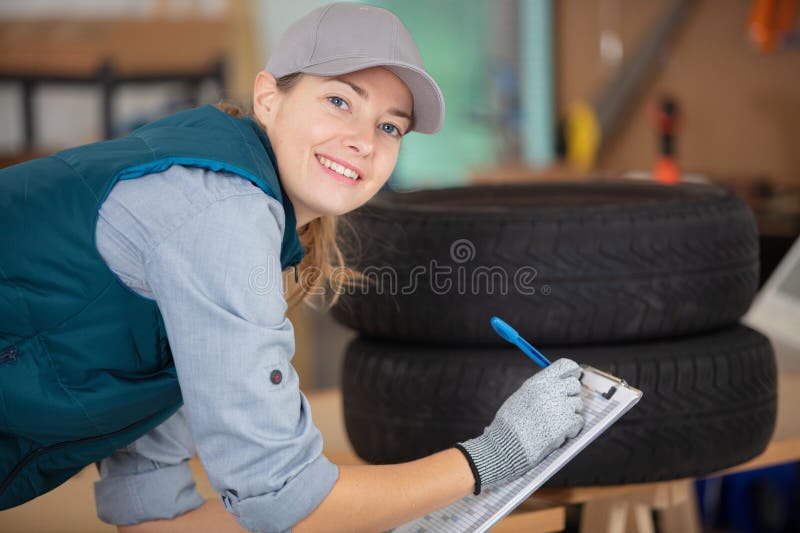 Cheerful Smiling Female Technician Working in Service Station Stock ...