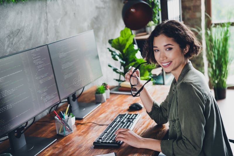 Smiling Programmer Working on Coding Project in a Modern Home Office with Multiple Computer ...