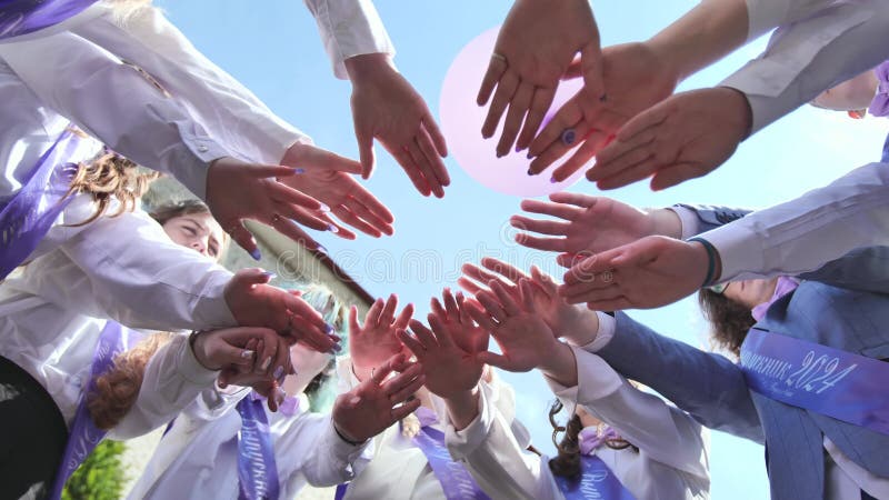 Cheerful Students Join Hands in a Circle, Celebrating Graduation and ...