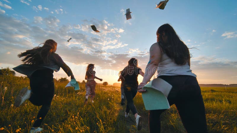 Cheerful Students Run Throwing Notebooks after School at Sunset. Stock ...