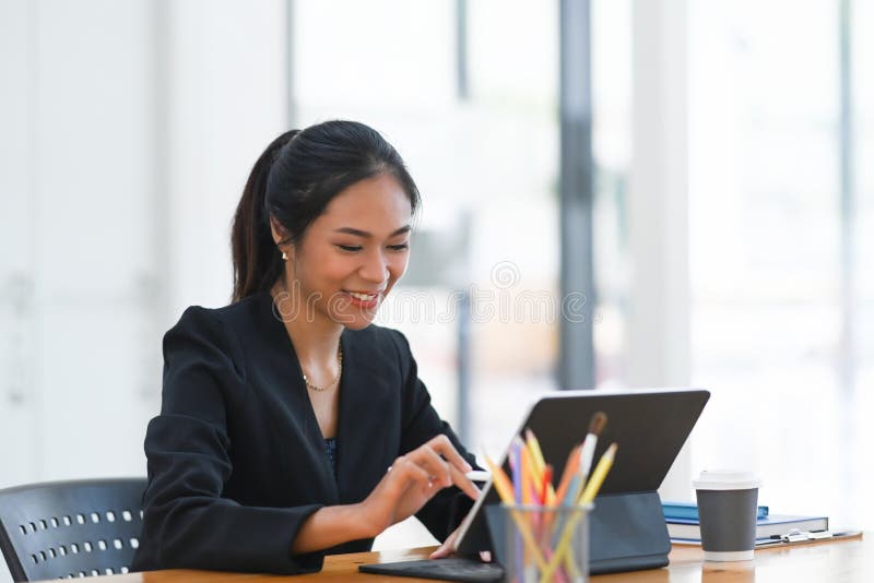 Stylish Woman Using Stylus Pen Writing on Computer Tablet while Sitting ...