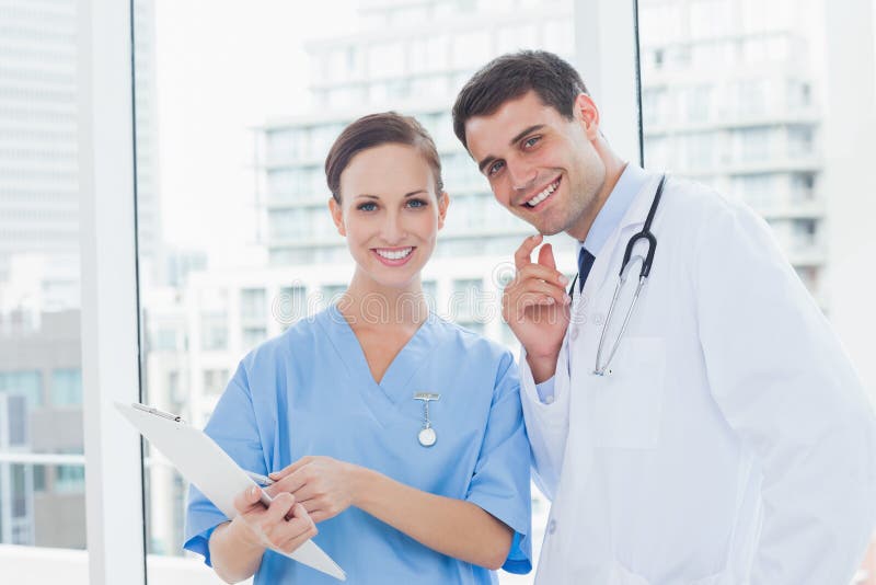 Cheerful Surgeon and Doctor Posing while Working Together Stock Photo ...