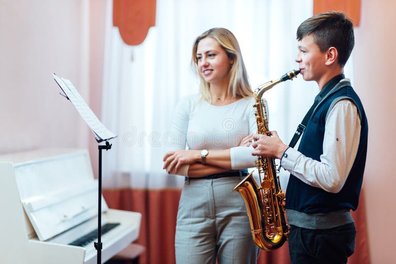 Cheerful Student Boy Sitting with Saxophone before Music Lesson Stock ...