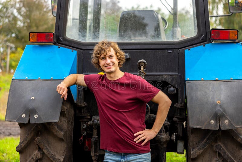 Cheerful Tractor Driver Posing for the Camera Outside Stock Image ...