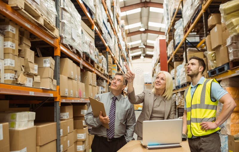 Cheerful Warehouse Manager Using Portable Computer in Storage Area ...