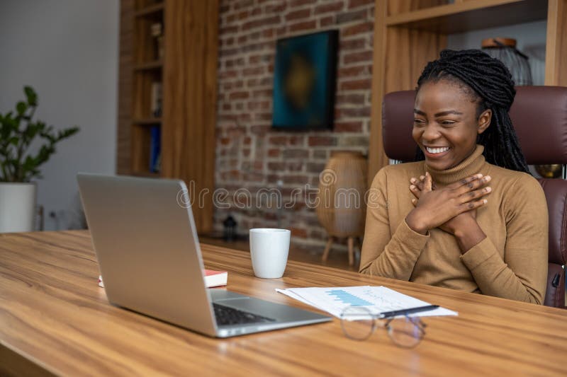 Cheerful Woman with Dreadlocks Using Laptop Engages in Virtual ...