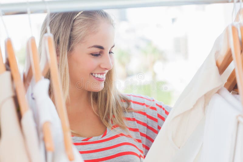 Cheerful Woman Looking at Clothes Stock Image - Image of clothes ...