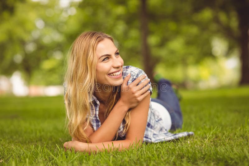 Cheerful Woman Lying on Front at Park Stock Photo - Image of ...