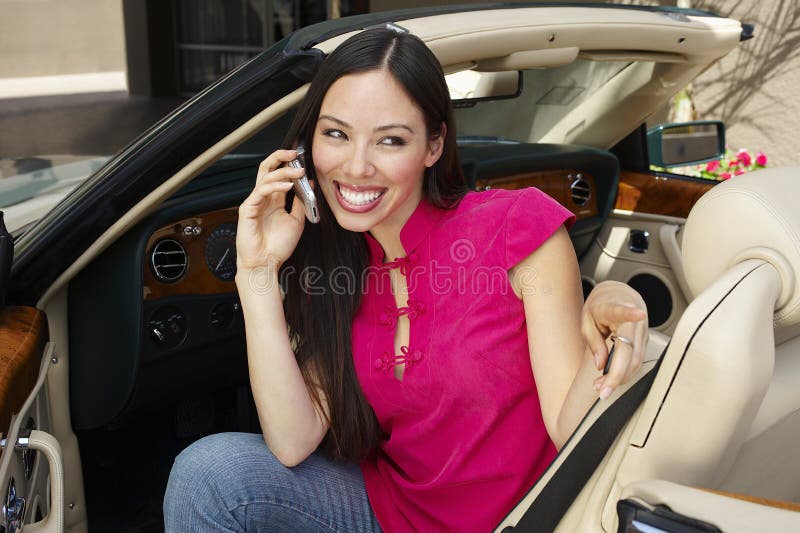 Cheerful Woman Sitting in Convertible Using Cell Phone Stock Image ...