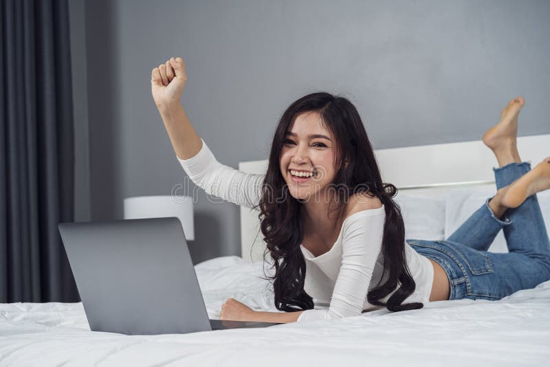 Cheerful Woman Using Laptop Computer on Bed Stock Image - Image of ...