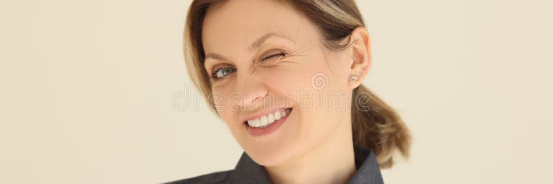 Cheerful Woman Winks Eye Looking At Camera And Smiling Stock Image