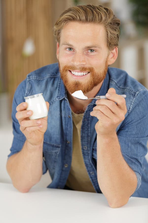Cheerful Young Asian Man Eating Yogurt for Breakfast Stock Photo ...