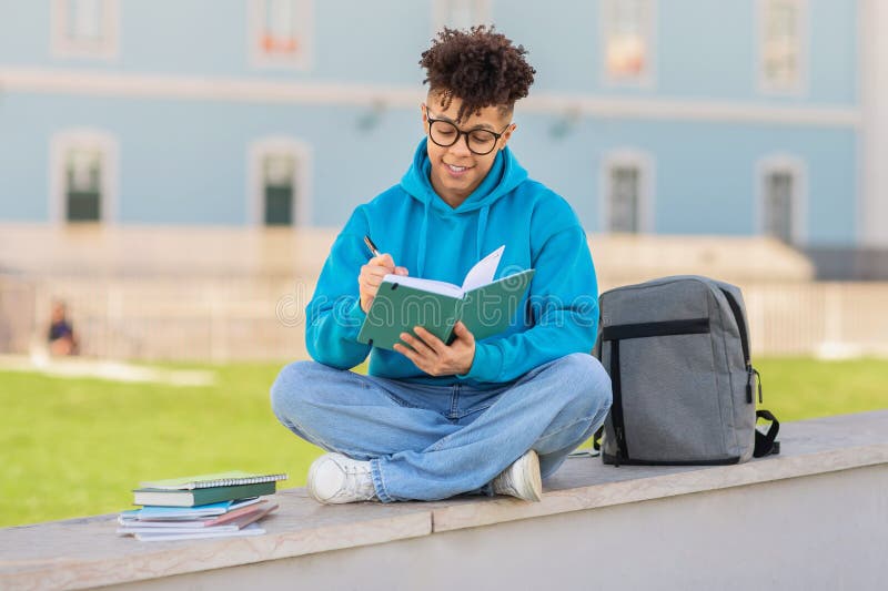 Cheerful Young Brazilian Student Guy Taking Notes Learning Outside ...