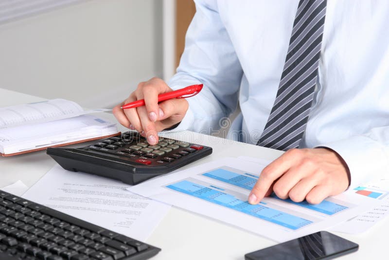 Cheerful Young Businessman Sitting at the Table with Laptop and ...