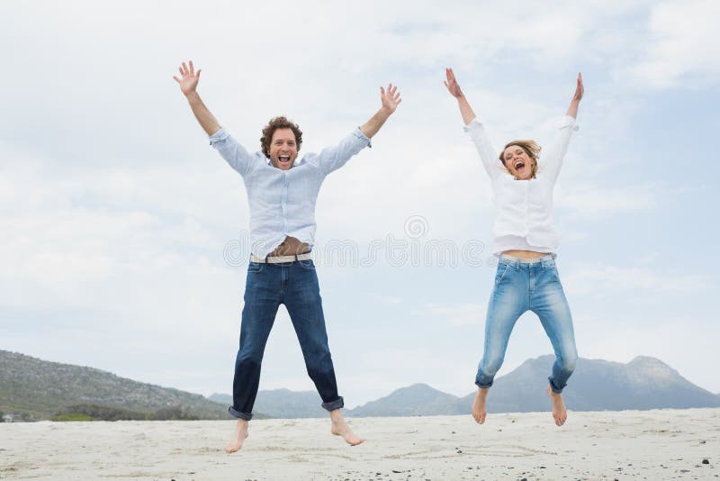 Cheerful Young Couple Jumping at Beach Stock Image - Image of pretty ...
