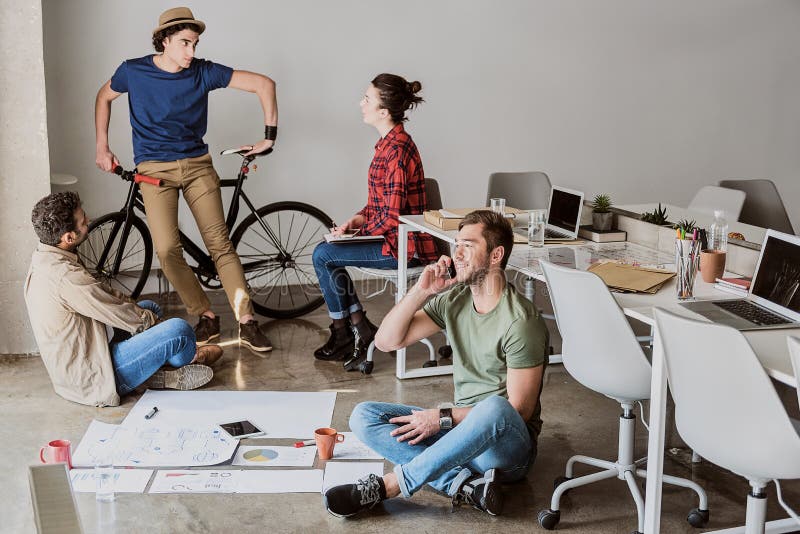 Cheerful Young Coworkers Having Interesting Discussion Stock Photo ...