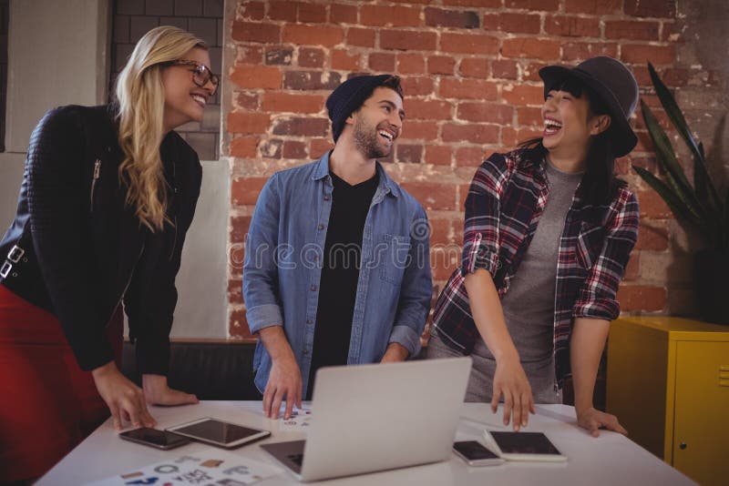 Cheerful Young Creative Team Using Technologies at Coffee Shop Stock ...