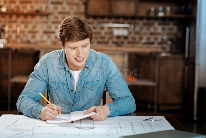 Cheerful Young Engineer Doing Calculations for His Project Stock Image ...