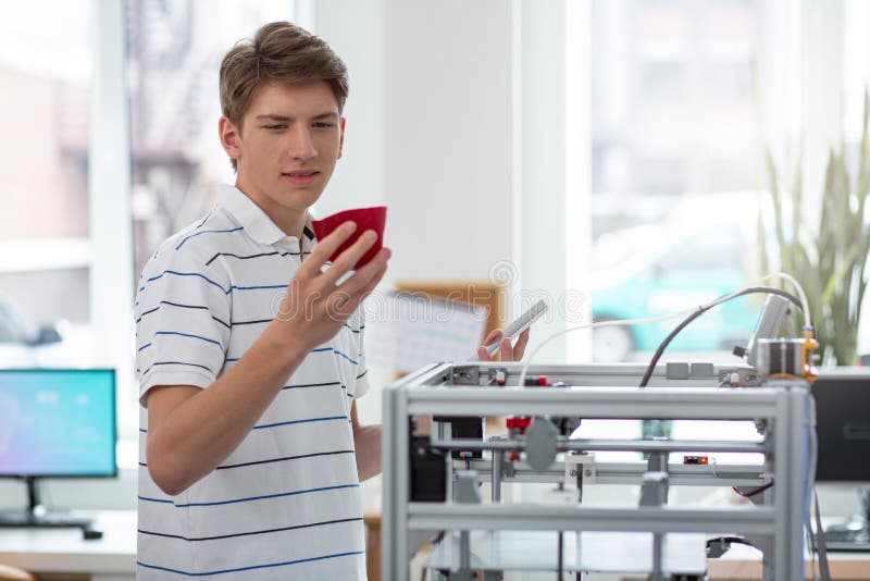 Cheerful Young Engineer Looking for Flaws in Bell Pepper Stock Photo ...