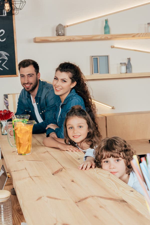 Cheerful Young Family in Cafe Stock Image - Image of complicity, happy ...