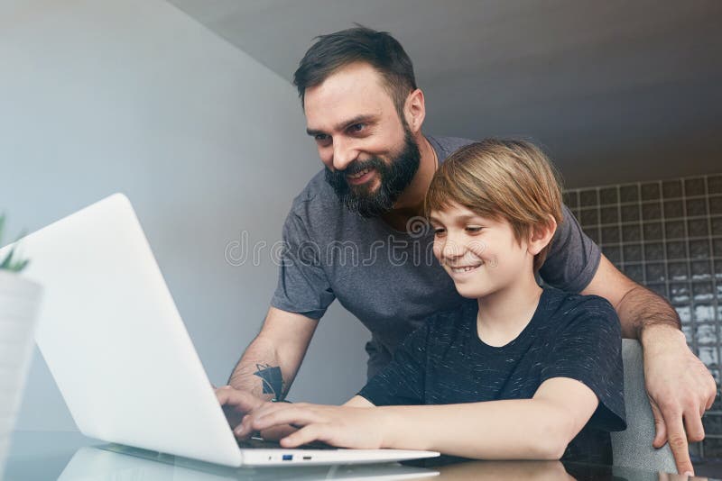 Cheerful Young Father with Cute Son Using Laptop Computer while Sitting ...