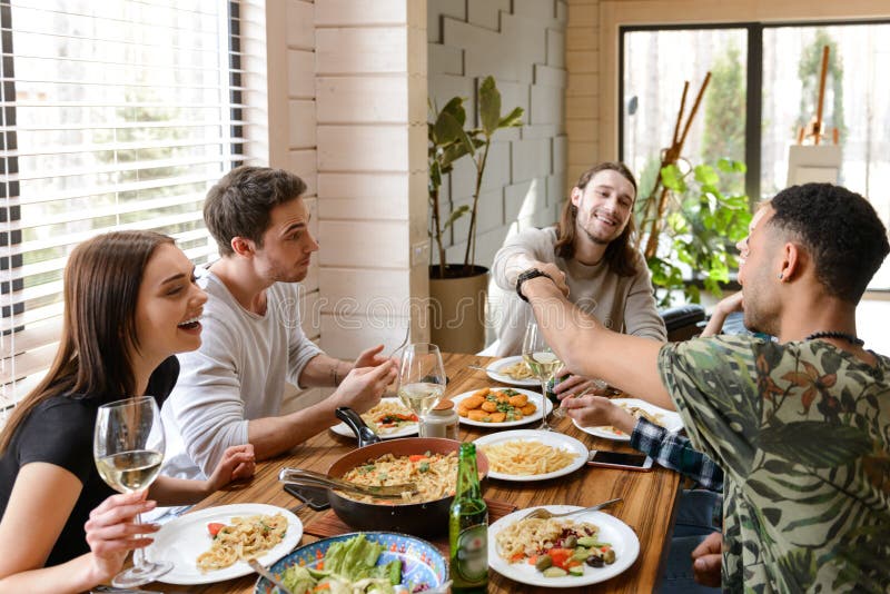 Cheerful Young Friends Eating and Having Fun at the Table Stock Photo ...