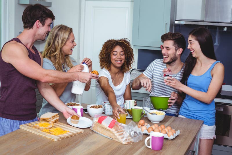 Cheerful Young Friends with Food Stock Photo - Image of holding ...
