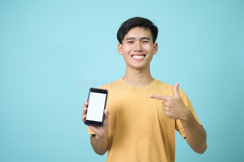 Cheerful Young Guy Pointing at Smartphone with White Screen Stock Photo ...
