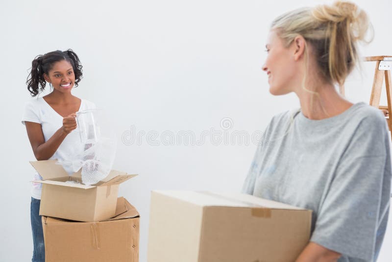 Cheerful Young Housemates Moving into New Home Stock Photo - Image of ...