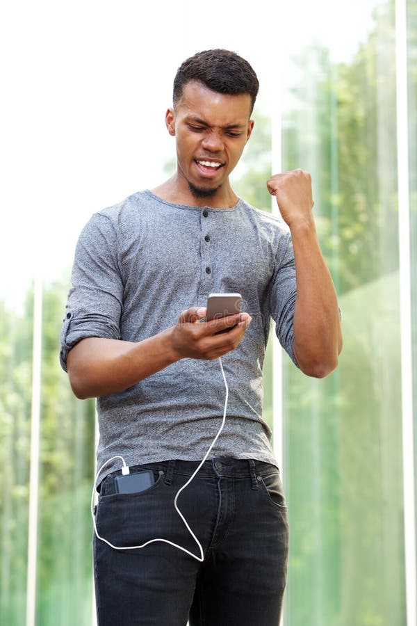 Cheerful Young Man Holding Cellphone Stock Photo - Image of battery ...