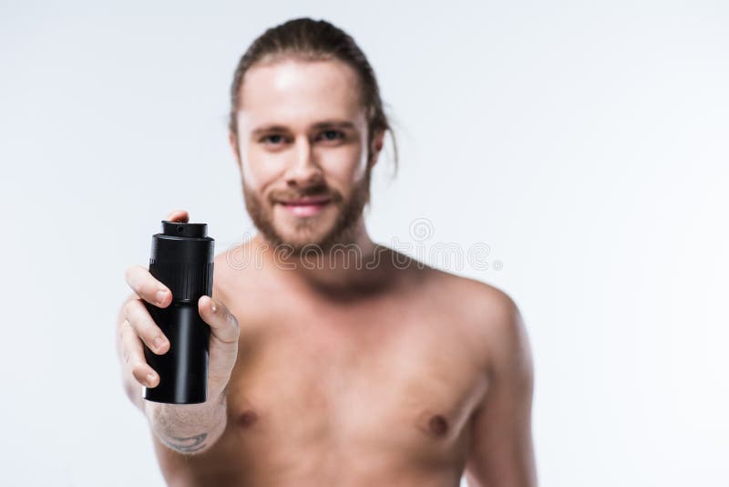 Cheerful Young Man Holding Deodorant Spray in Outstretched Stock Image ...