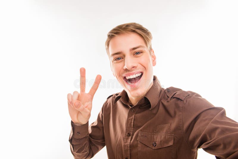 Cheerful Young Man Making Selfie and Gesturing with Two Fingers Stock Image - Image of cheerful ...