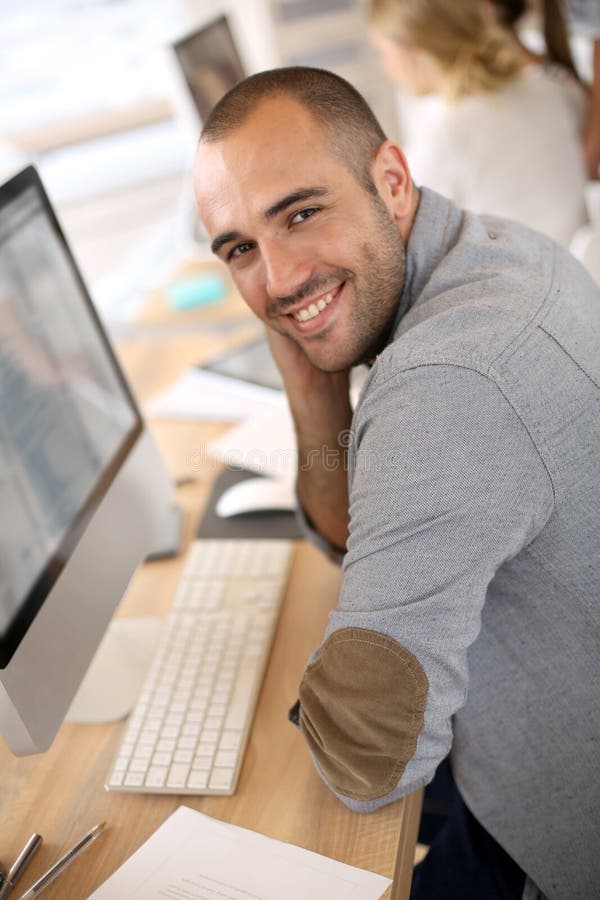 Cheerful Young Man Sitting on Desktop Computer Stock Photo - Image of ...