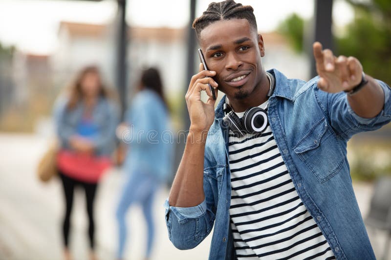 Cheerful Young Man Talking on Phone and Showing Way Stock Image - Image ...
