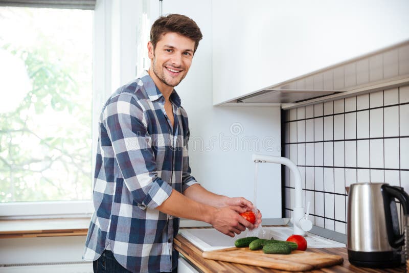 Cheerful Young Man Washing Vegetables on the Kitchen Stock Photo ...