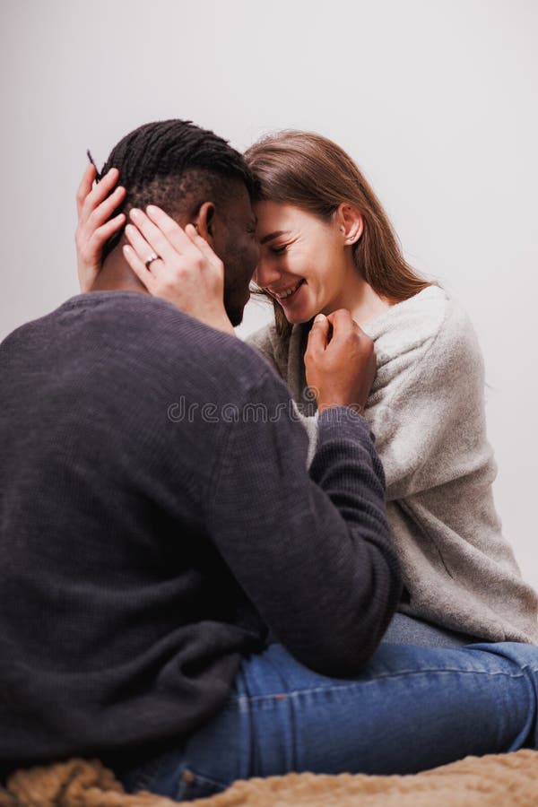 Cheerful Young Multiethnic Couple Cuddling on Bed at Home Stock Photo ...