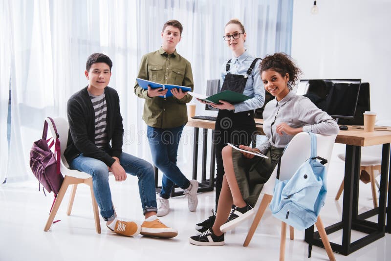 Cheerful Young Students with Exercise Books and Tablet Looking Stock ...